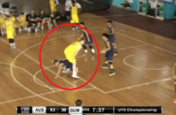 Basketball player runs through opponent's legs, forces missed shot