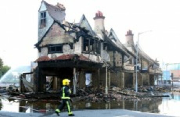 In photos: Fire crews work through the night as rioting spreads from London