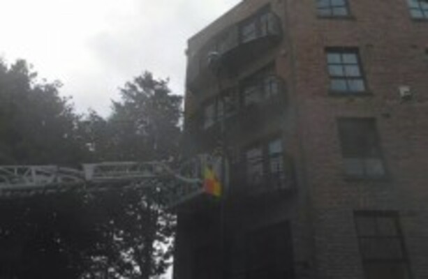 Pics: Woman rescued from Dublin apartment balcony after fire started in ...