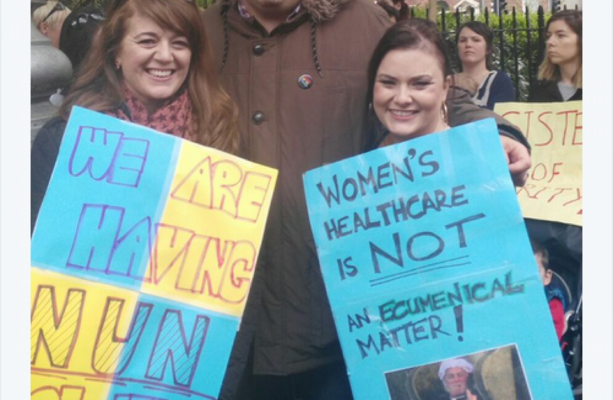 A woman carrying a Father Ted sign at the maternity hospital protest ...