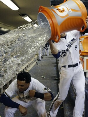 Perfectly-timed photo of a baseball player ducking a post-match soaking
