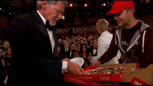 Celebrities helping themselves to the pizza Ellen ordered at the Oscars