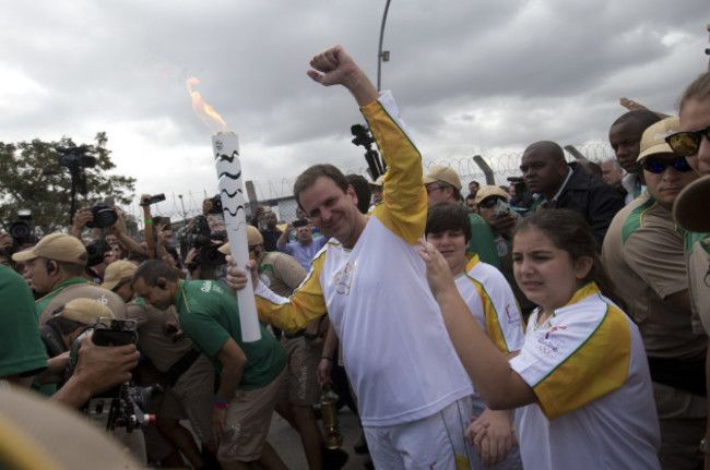 Riot police disperse protesters with tear gas as Olympic torch-bearer ...