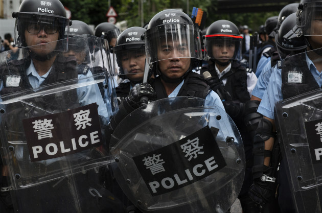 Hong Kong protest: Riot police fire tear gas on crowd hours after group ...